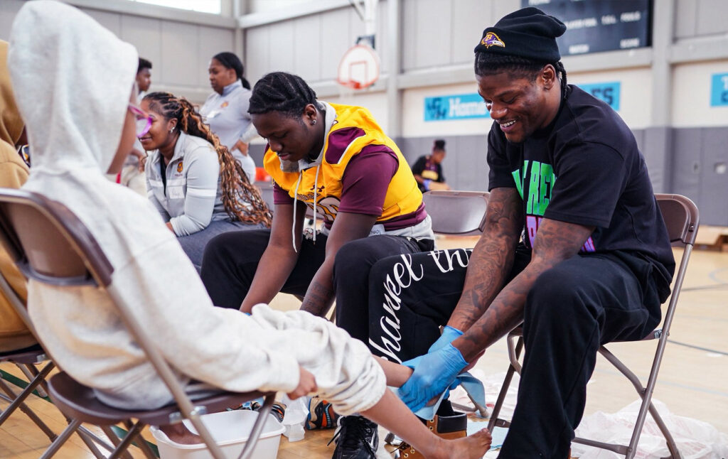NFL stars model Jesus’ example by washing students’ feet at local ...